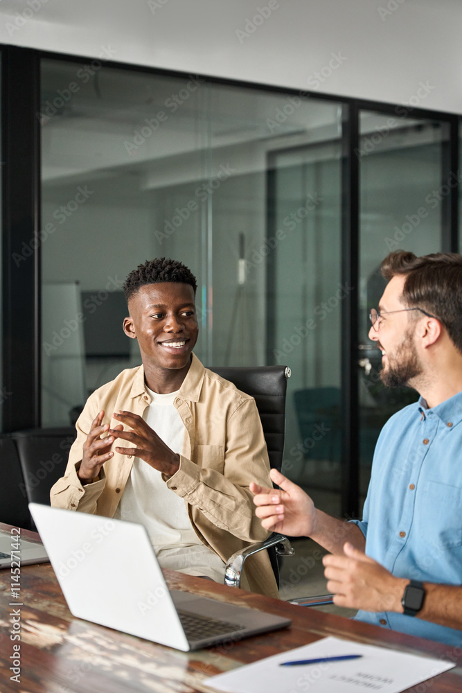 Vertical photo of two happy busy diverse professional male coworkers ...