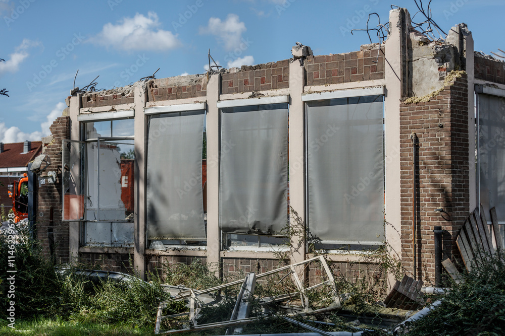 Demolition of a brick building; partially collapsed structure with ...