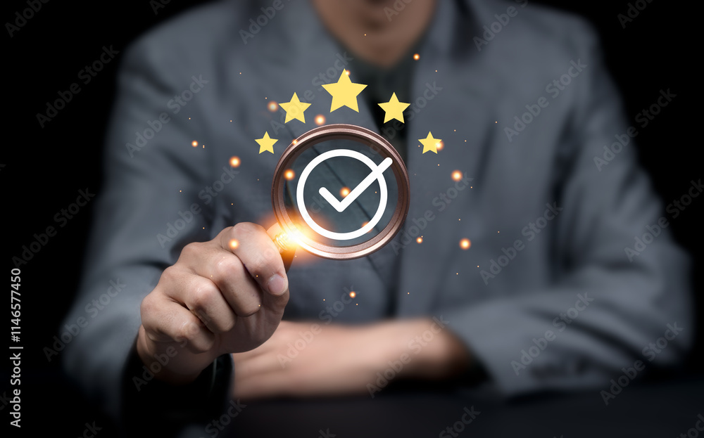 Businessman use Magnifying glass reveals an aligned icon, symbolizing ...