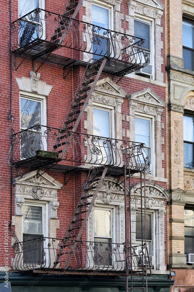 New York City, old apartment building with external fire ladder and ...
