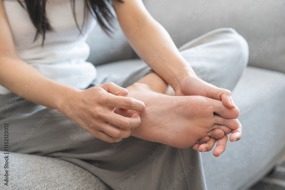 Foot pain, ache asian young woman hand scratch feet, itch foot, problem itchy skin on carpet at ...