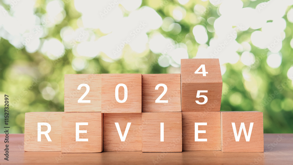 Review 2025. Flips wooden cube and changes words Review 2024 to Review 2025. Business growth ...