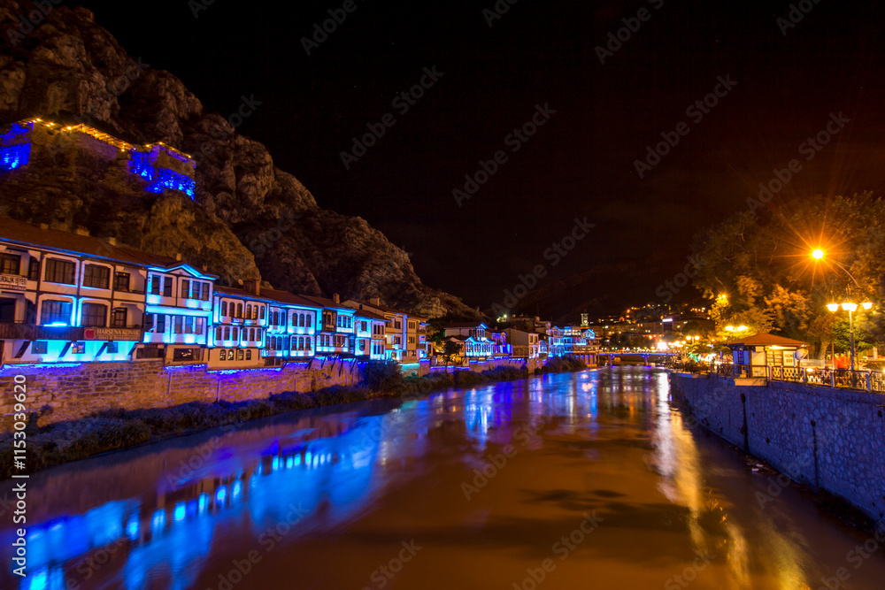 Old Ottoman houses night and mirrored colorful view by the Yesilirmak ...