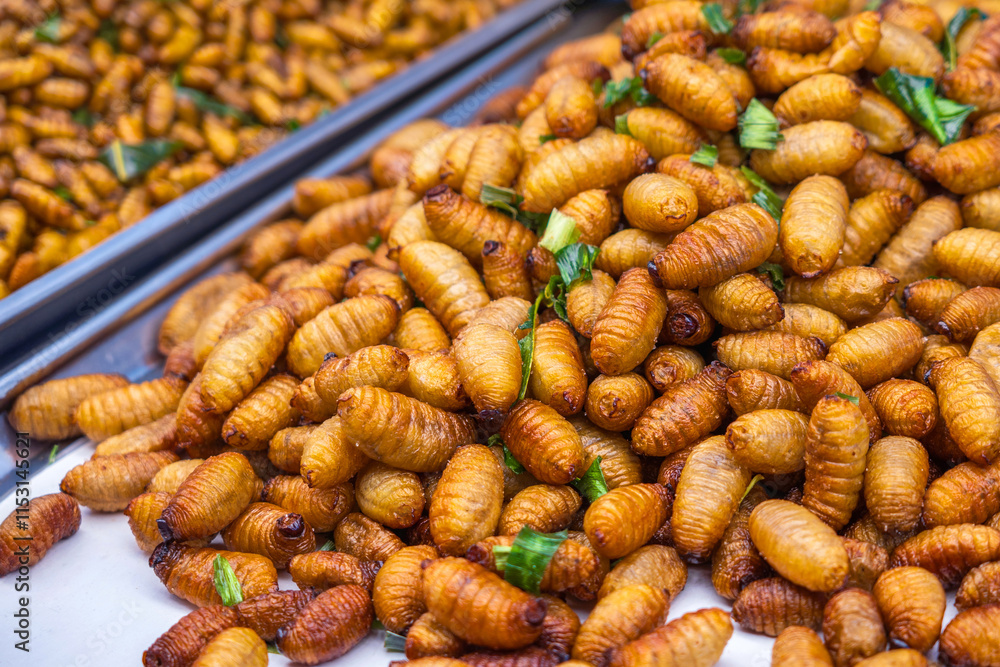 Fried Sago Worm larvae of red palm weevil with pandan leaves and herbs ...