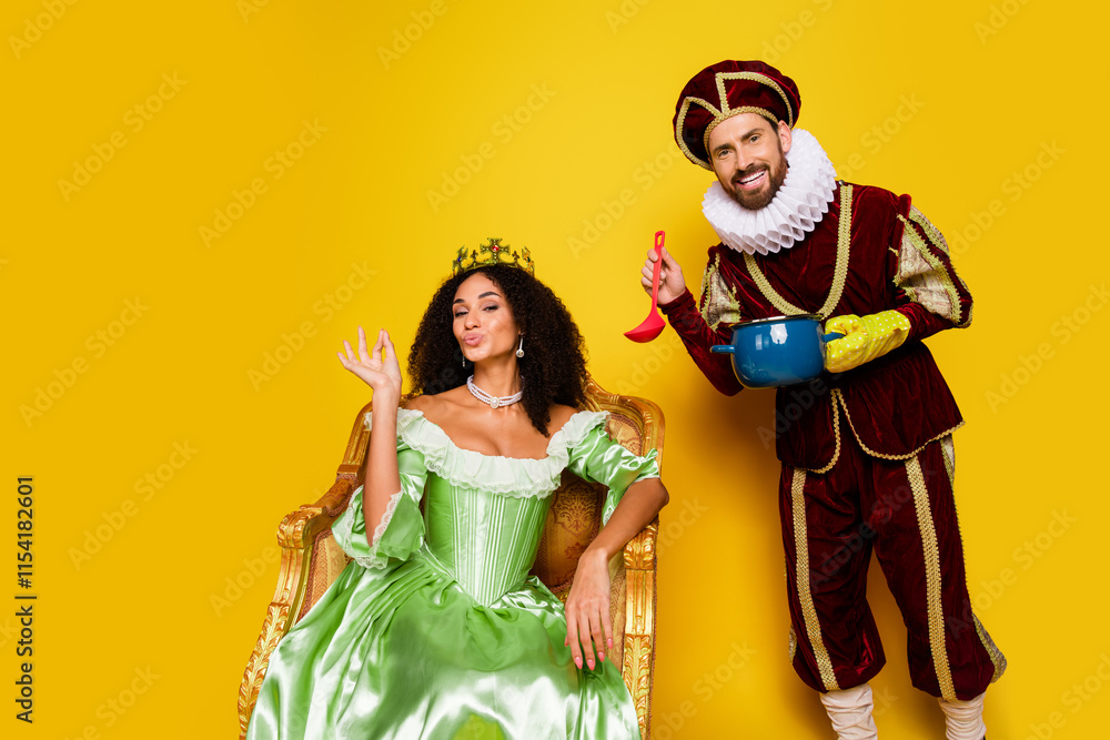 Royal couple in elegant costumes posing against vivid yellow background ...