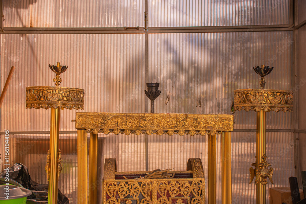 Ornate golden altar with candlesticks in a sunlit enclosure. Stock ...
