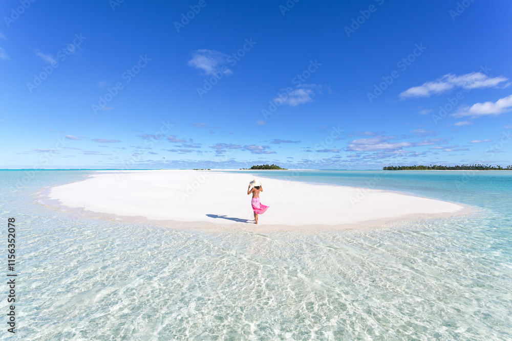 Woman walking on a sandbar in the lagoon of Honeymoon Island, Aitutaki ...
