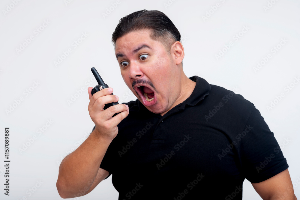 Angry and crass middle-aged man shouting into a two-way radio with ...