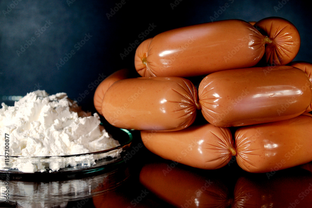 small sausages stacked in a hill with a pinch of white powder (starch ...
