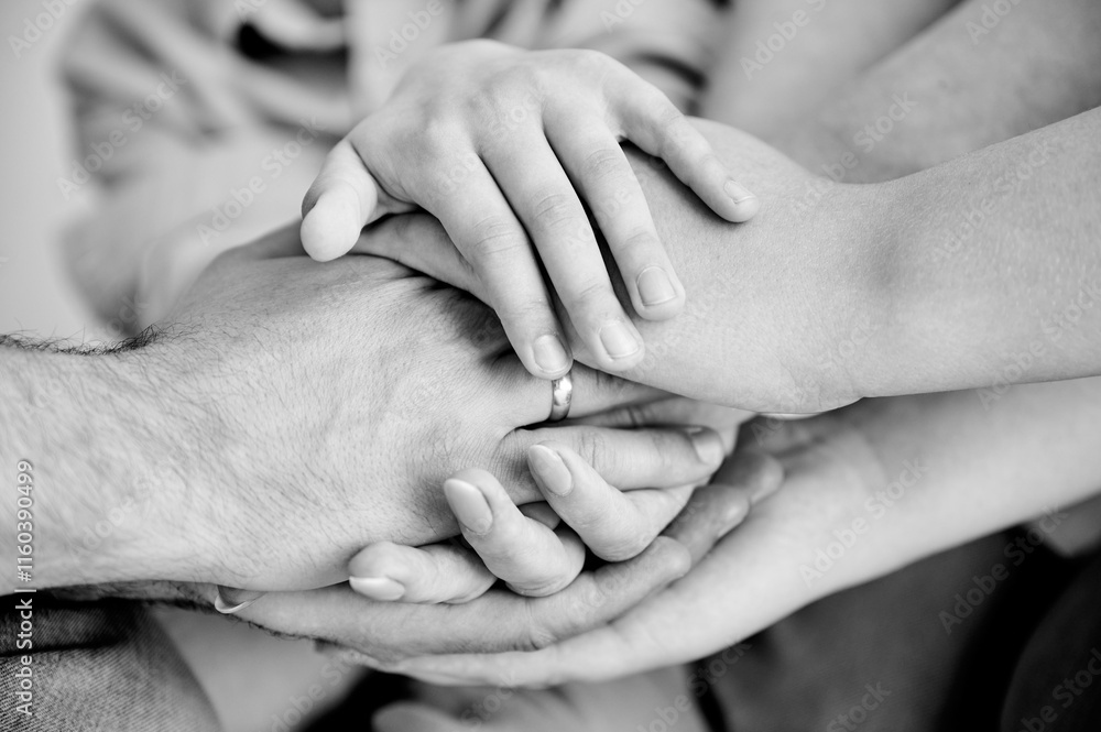 Cute family putting stacked hands together promising help and support ...