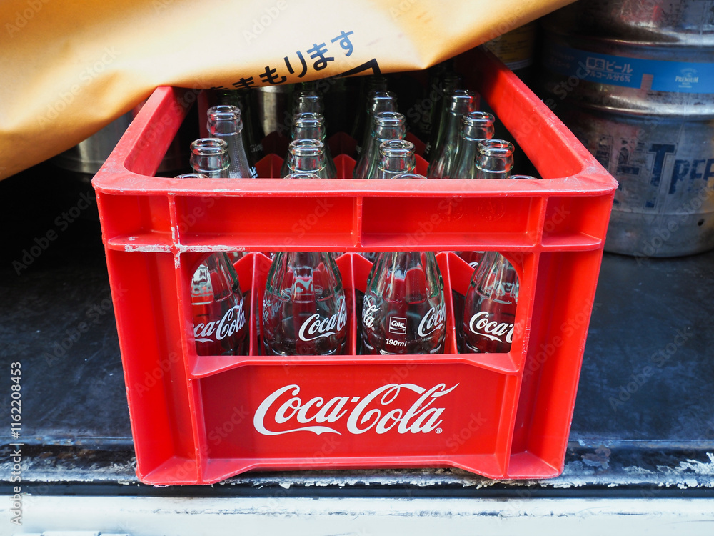 TOKYO, JAPAN - December 29, 2024: A crate containing empty glass Coca ...