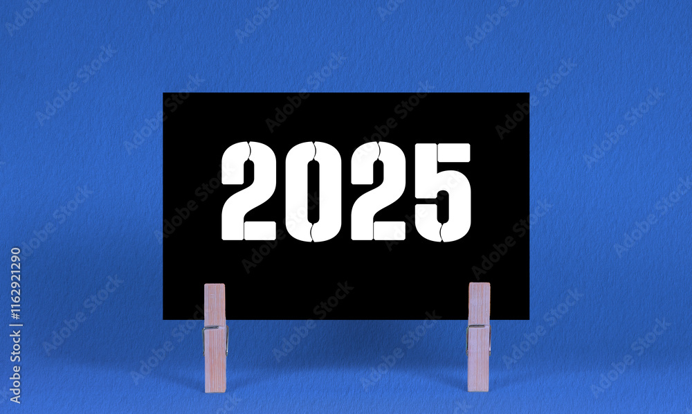 2025 Symbol. Concept words 2025 on Black rectangle Paper Held by Wooden ...