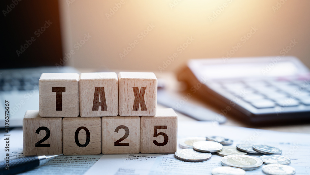 tax 2025 symbol. word TAX 2025 on a calculator with documents on the ...