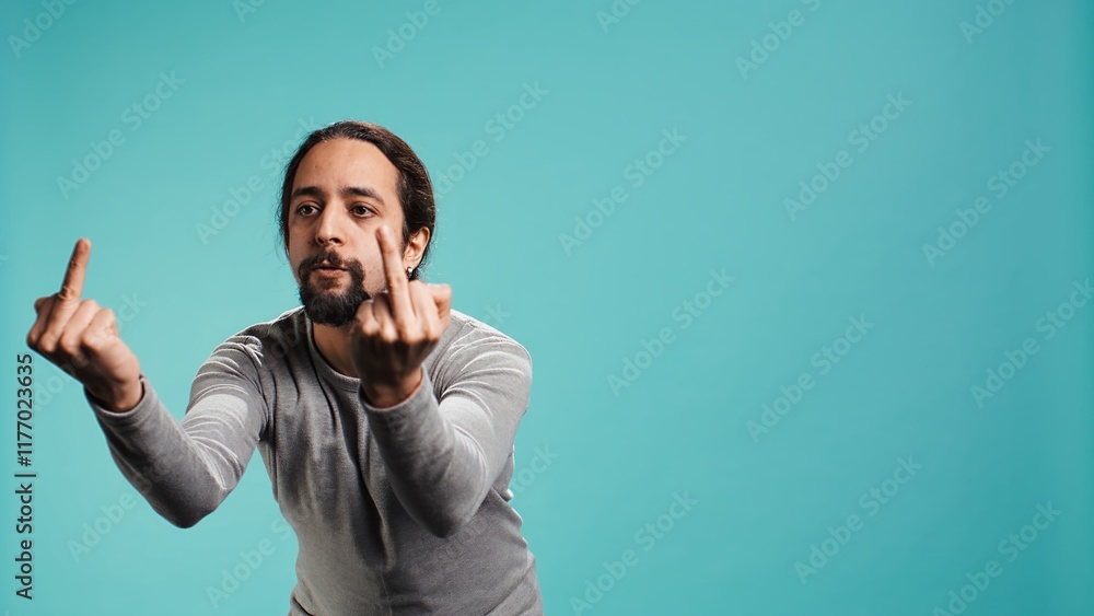 Irked man fighting with friend, doing middle finger sign gesturing ...