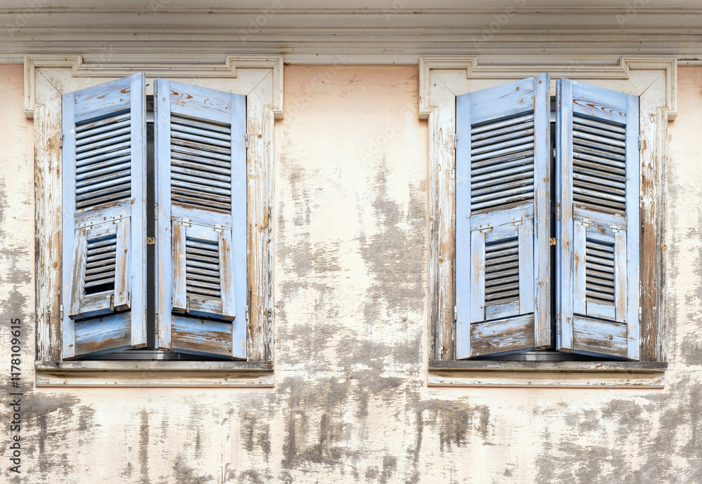 Old weathered house facade with two blue shuttered windows Stock Photo | Adobe Stock