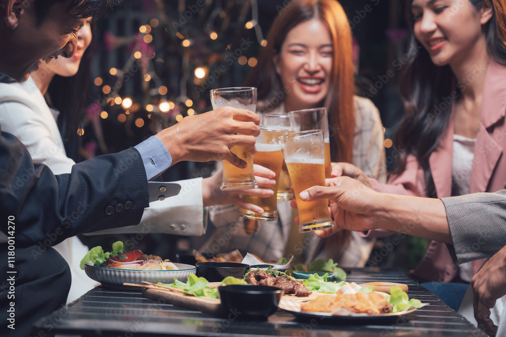 Cheers to Success: Friends toasting beers at a lively restaurant ...