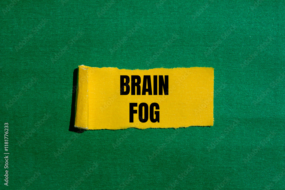 Brain fog message written on ripped torn yellow paper piece with green ...