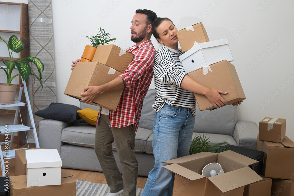 Moving Together: A young couple, proud homeowners, carries a heavy ...
