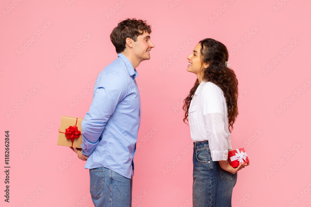 Romantic couple hiding gifts for Valentine's Day or anniversary behind ...