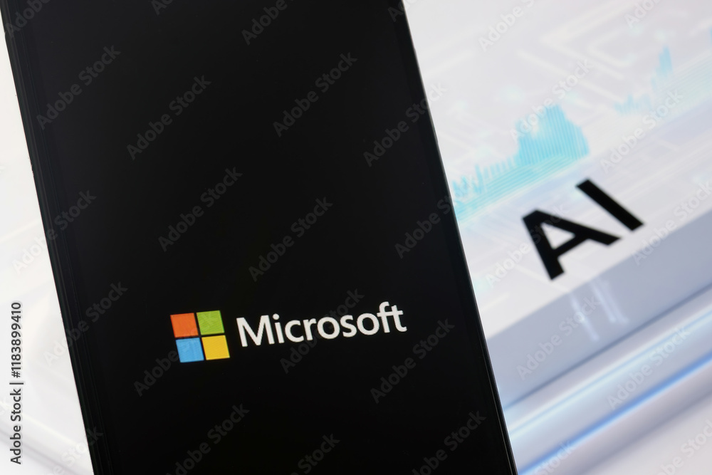 Foto de Stock Microsoft logo is displayed on the smartphone, while a ...