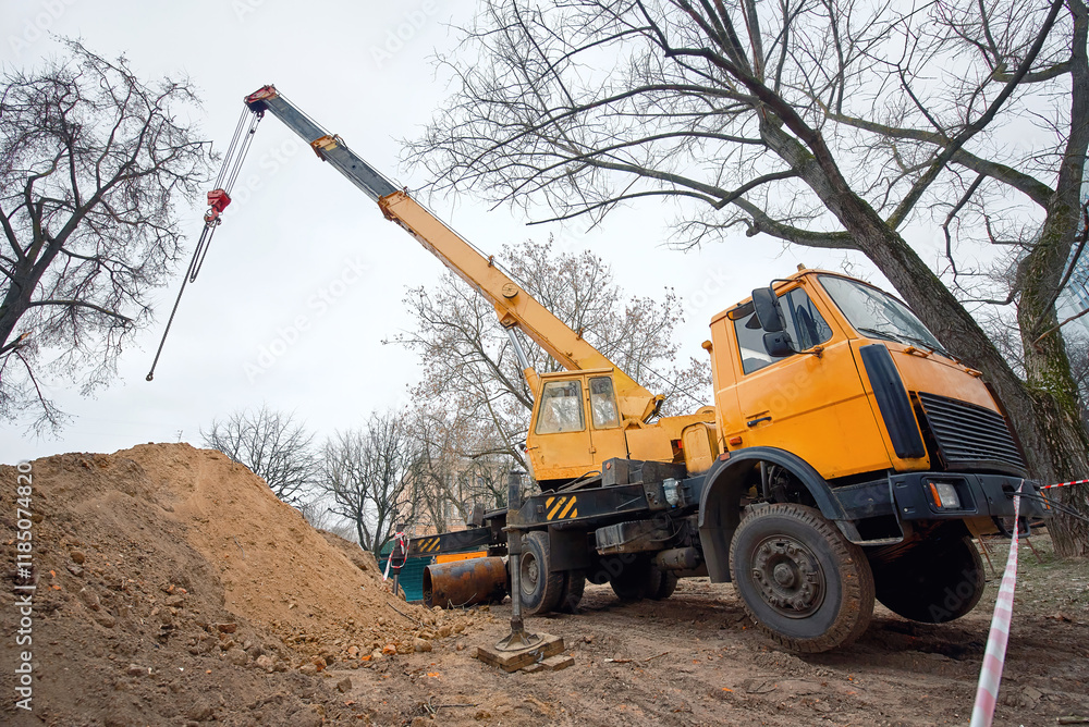Replacement pipe. Pipes installed in trench by heavy crane truck ...