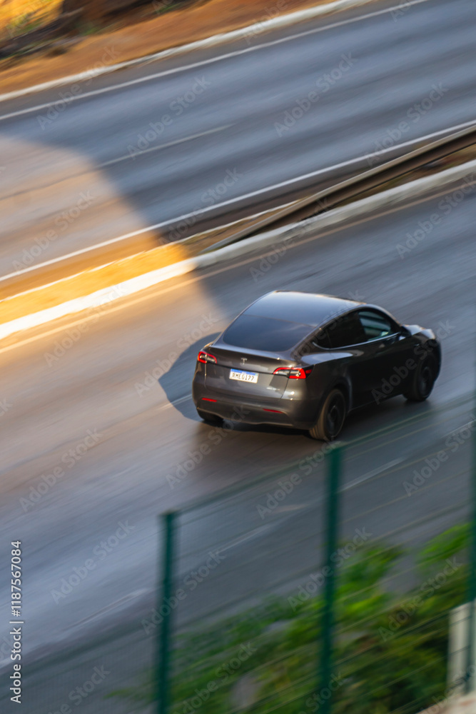Grey Tesla Model Y cruising city highway, Luxury Electric SUV in ...