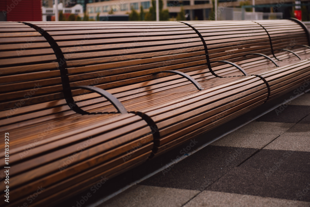 Design of urban public space. Modern long wooden bench in the park ...