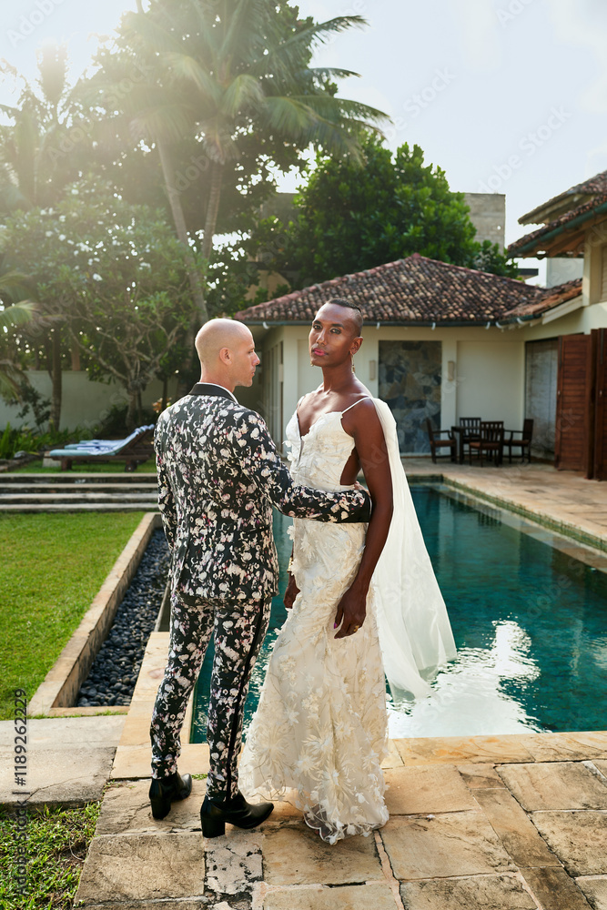 LGBTQ wedding at tropical villa. Ambiguous gender person in dress as ...
