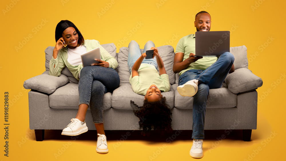 Gadgets addiction. Young black family of three holding and using ...