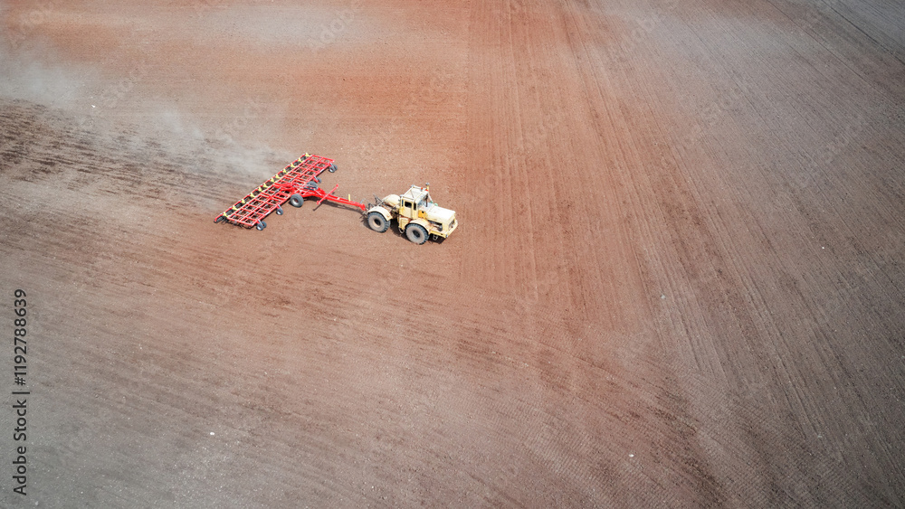 Pre-sowing field preparation. A single tractor with a trailed combined ...