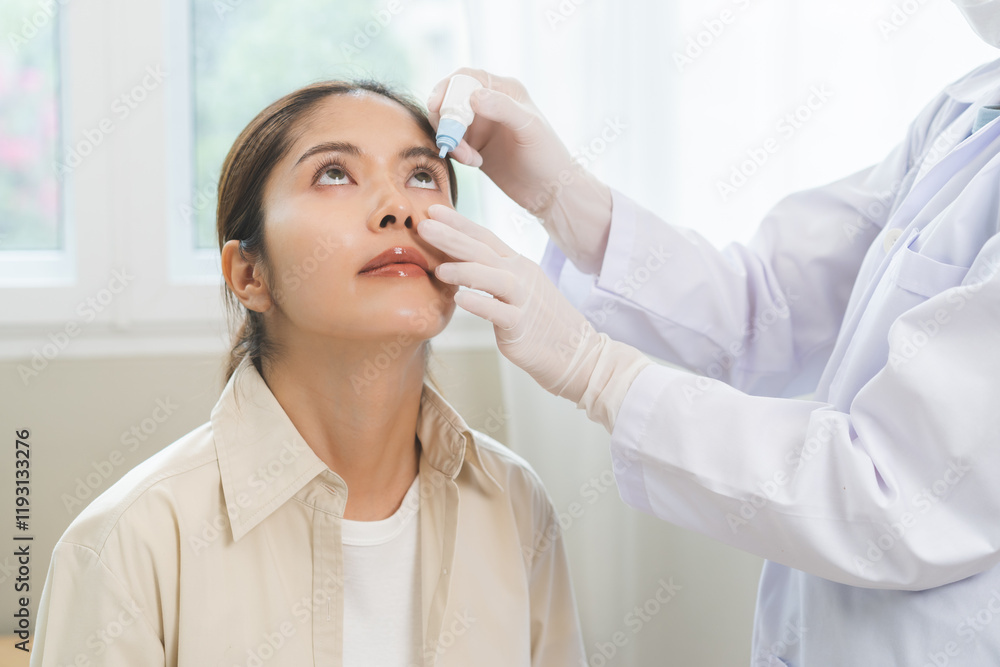 Health care concept, eye doctor eye drops to asian young woman patient ...