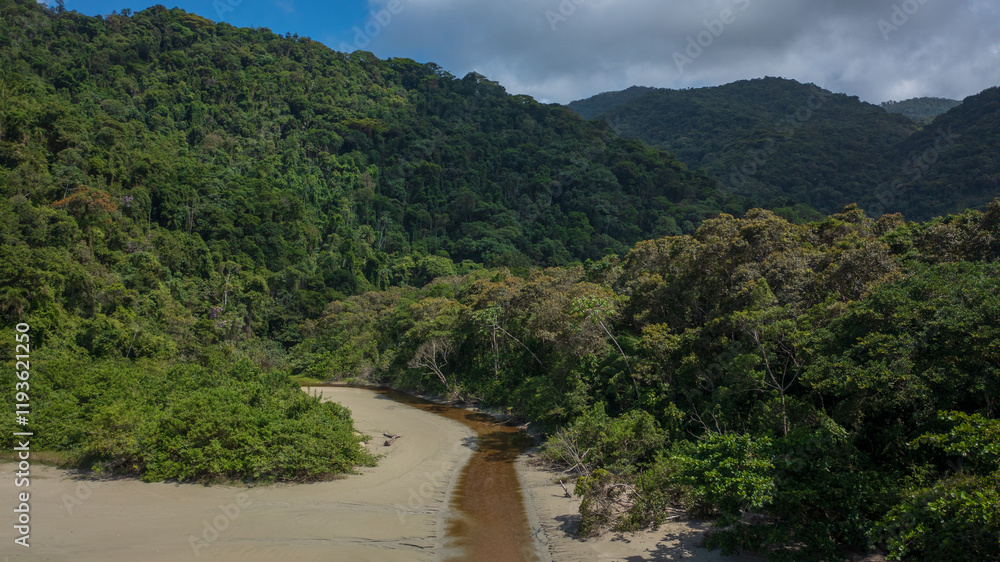 Beautiful aerial view of a small river that flows into Praia da Fazenda ...