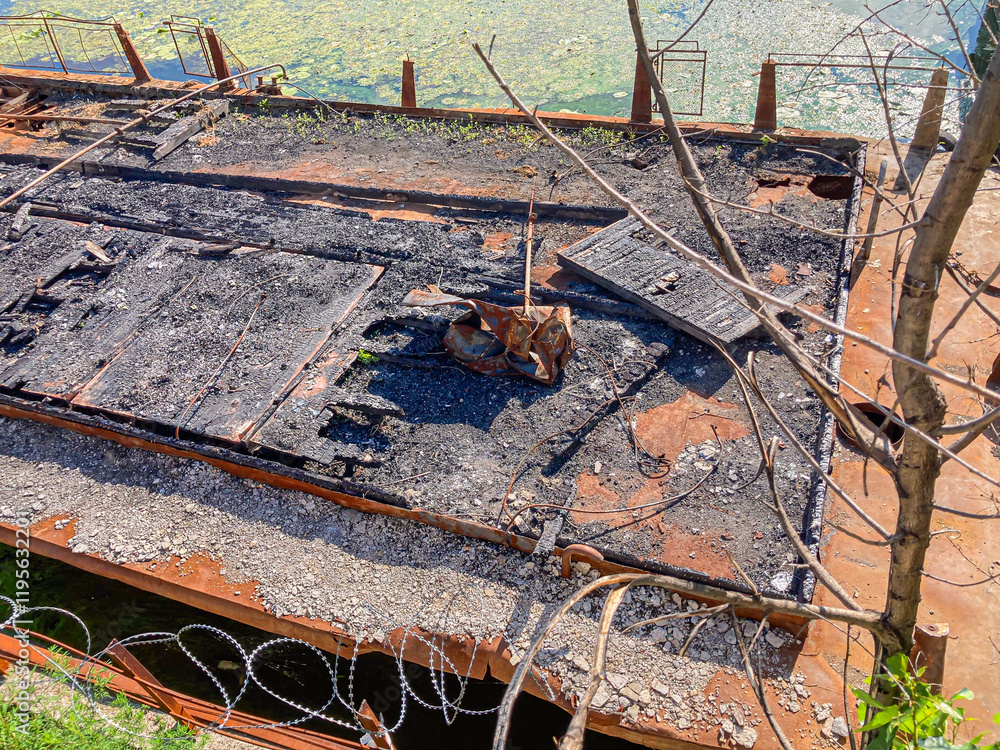 Image shows a scene of destruction with a severely damaged structure ...