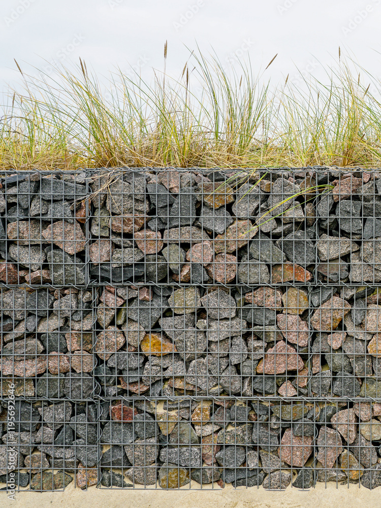 Gabion fence wall from steel mesh filled with granite stones, modern ...