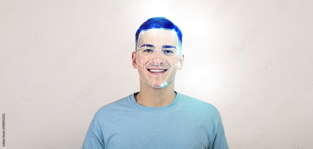 A young person is smiling as a futuristic facial recognition technology ...