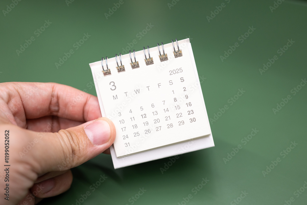 Hand holding mini calendar for MARCH 2025 background. Calendar concept ...