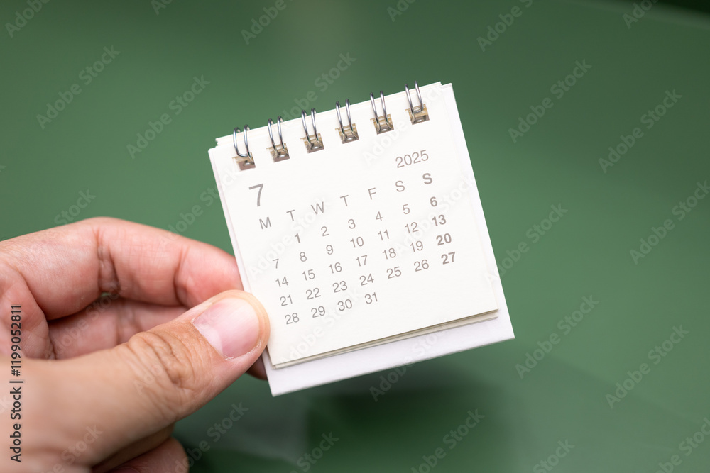 Hand holding mini calendar for JULY 2025 background. Calendar concept ...