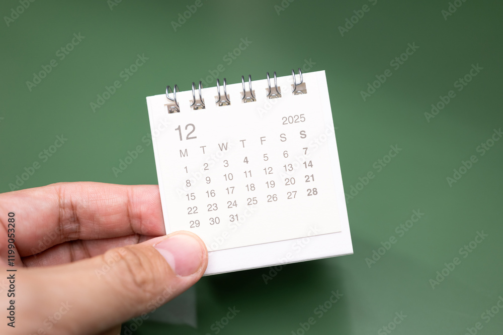 Hand holding mini calendar for 2025 DECEMBER background. Calendar ...