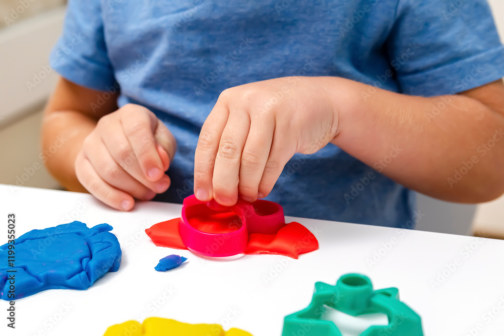 Foto de Stock Child boy playing,molding plasticine.Kid sculpts with ...