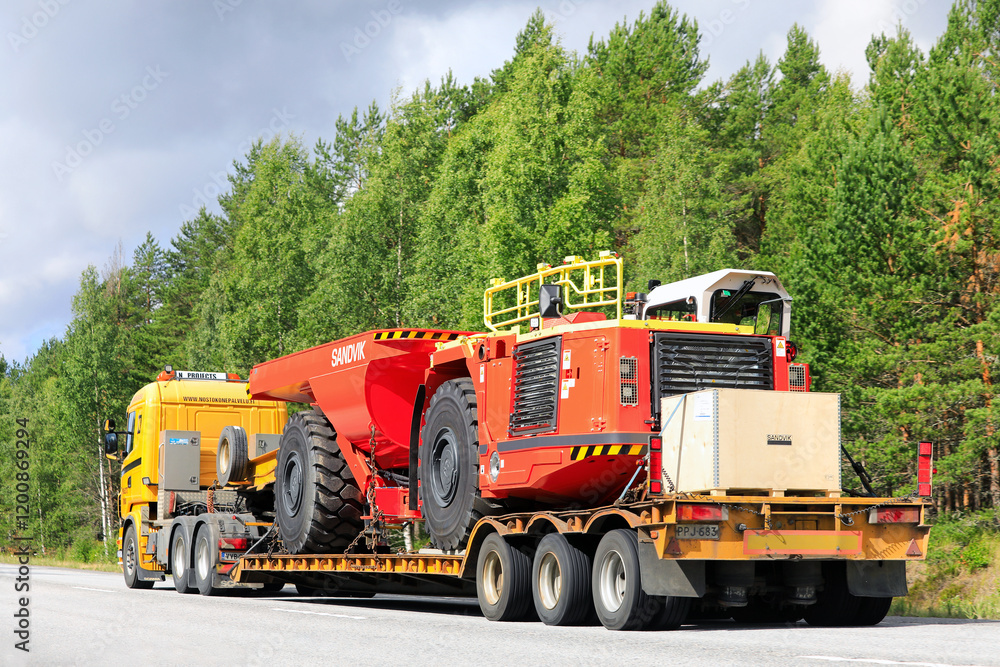 Yellow Scania lorry semi trailer hauls Sandvik underground truck ...