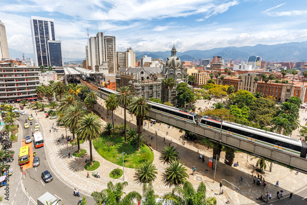 Medellin skyline with Metro de Medellín train at Plaza Botero in Medellin, Colombia Stock Photo ...
