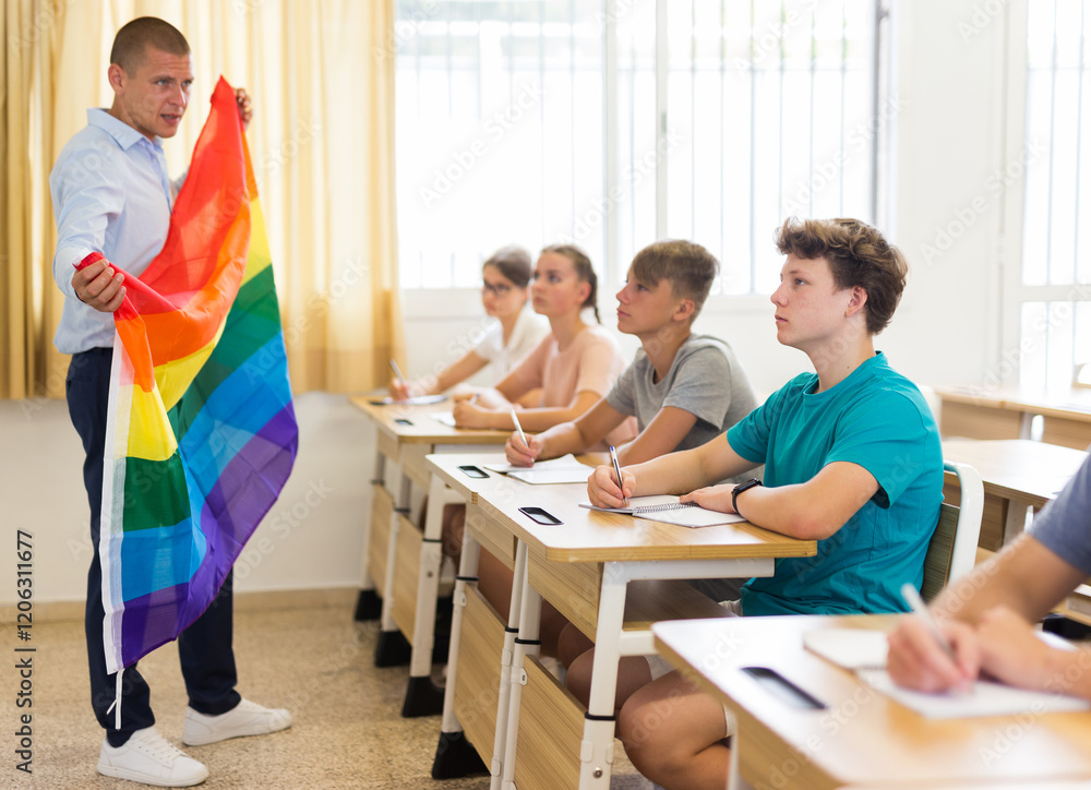 Teenage schoolboy sitting at lesson with classmates, listening young ...