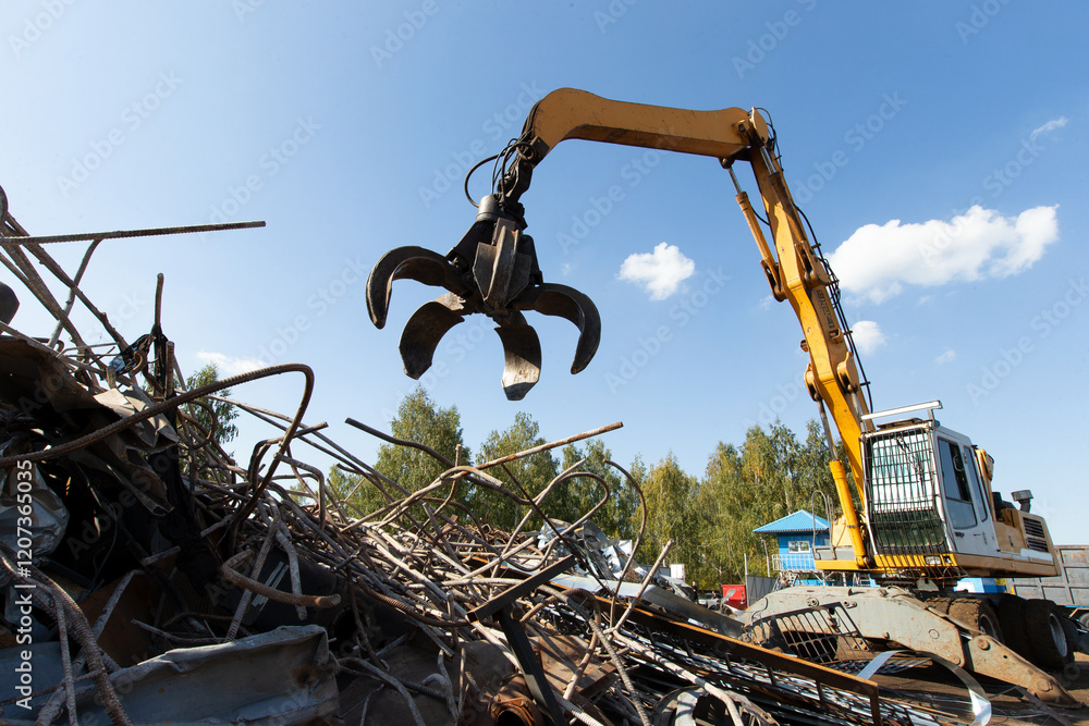 Excavator for loading scrap metal. Stock Photo | Adobe Stock