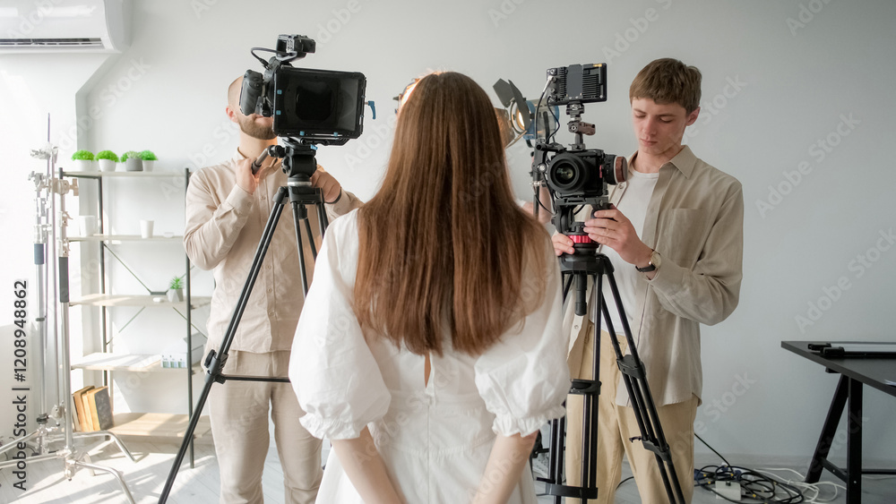 Shooting model. Backstage studio. Girl with loose hair stands front of ...