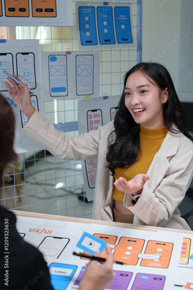 Asian female web designer pointing at ux ui smartphone templates ...