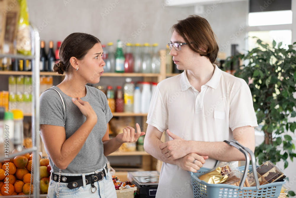 Husband and wife are standing in front of each other, shouting and ...