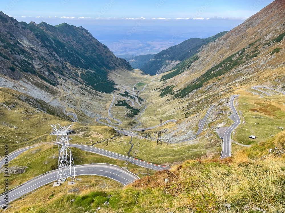 Winding roads through majestic peaks. This photo highlights adventure ...