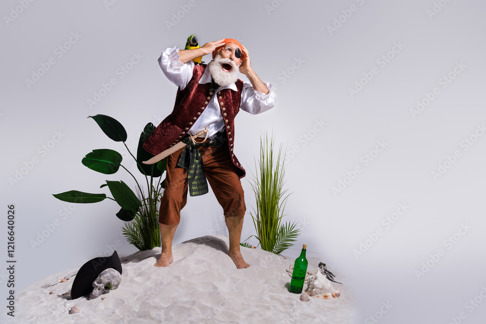 Eccentric bearded pirate captain posing on sandy island with tropical ...