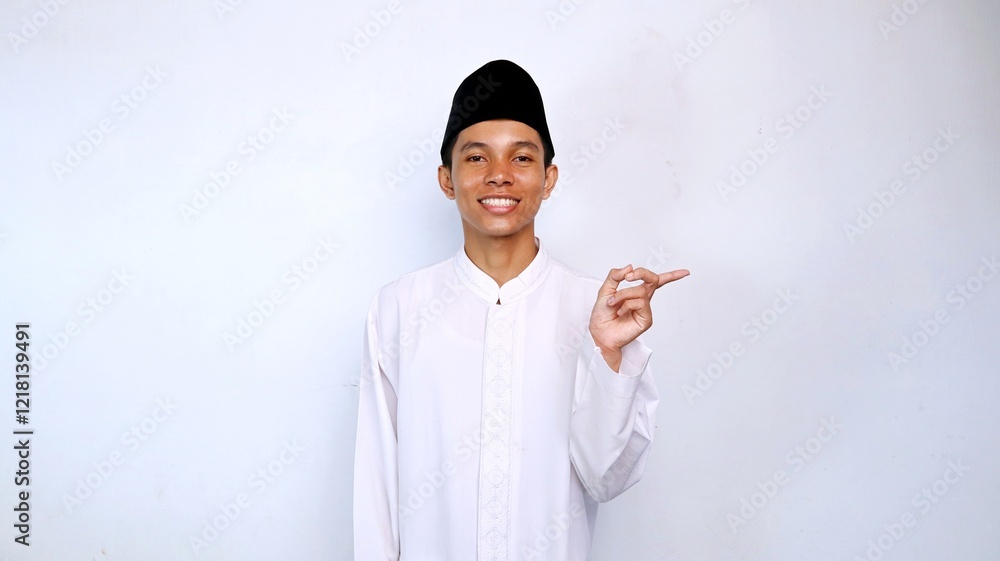Handsome young Asian Muslim smiling expression hand gesture pointing ...