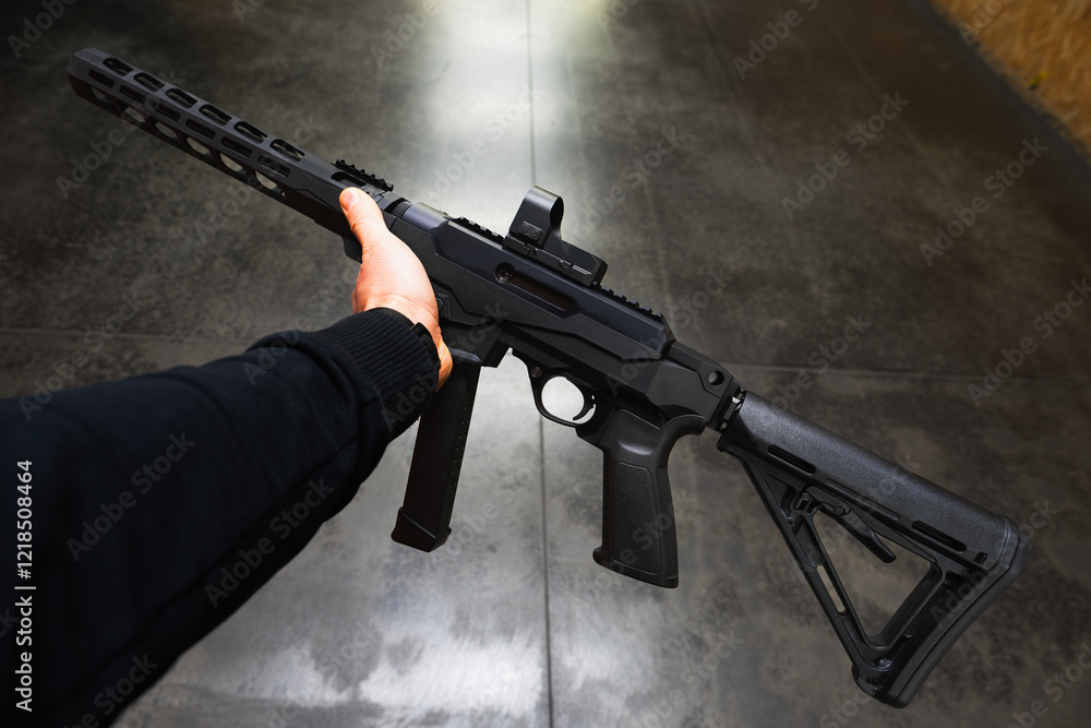 Tactical rifle for 9mm pistol caliber with red dot sight in mans hand ...